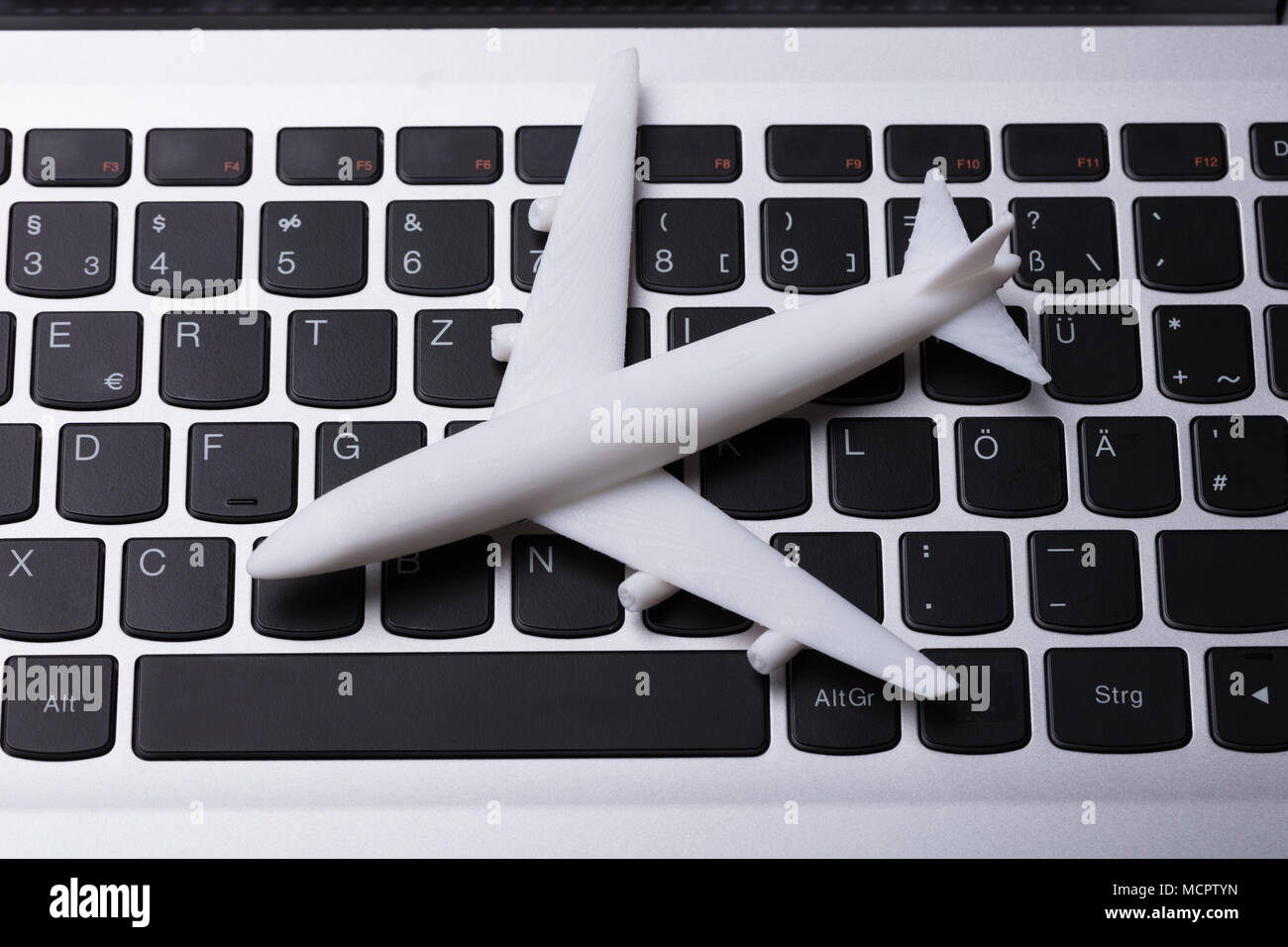 Elevated View Of White Airplane Miniature On Laptop Keypad Stock Photo ...