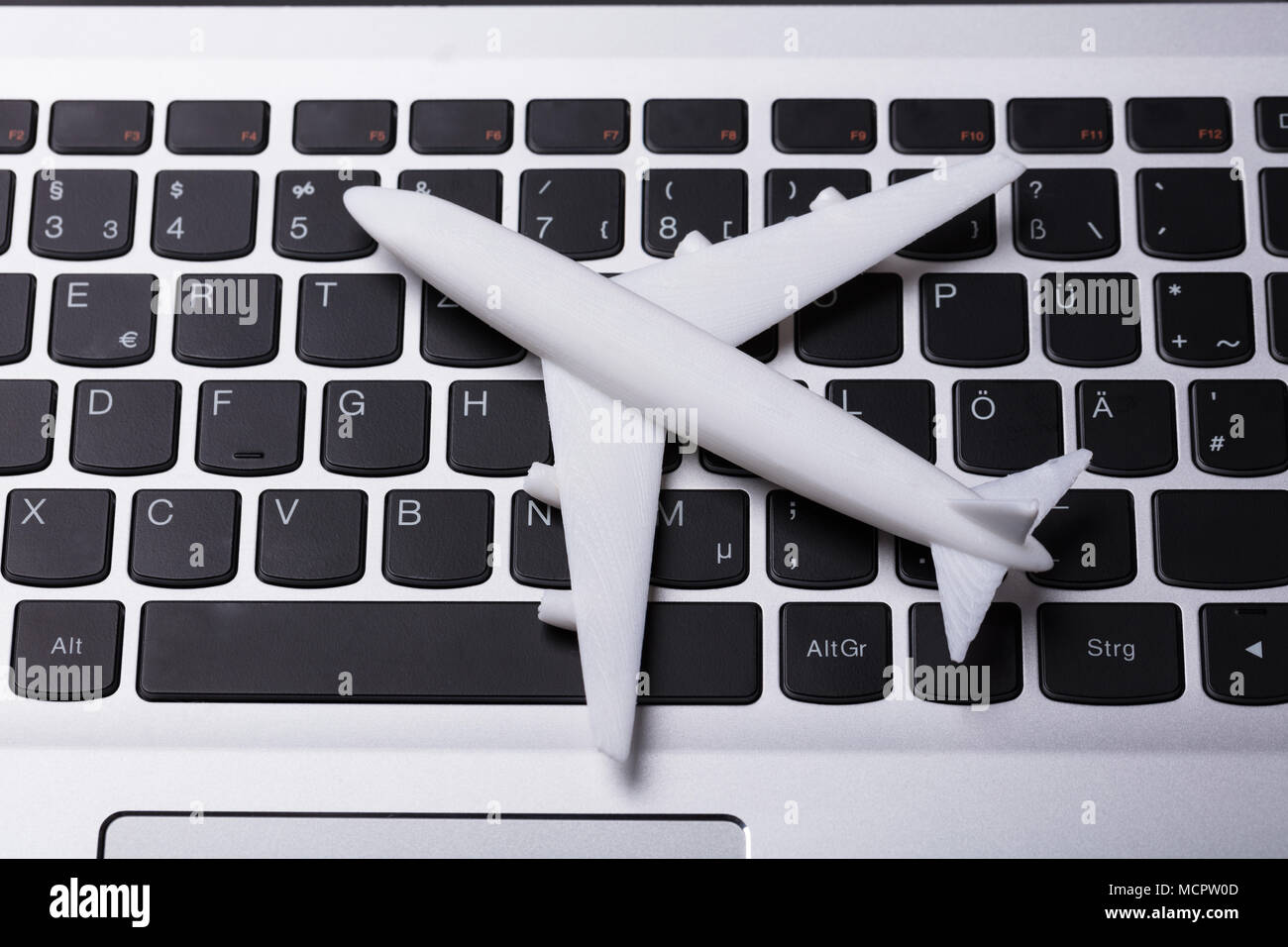 Elevated View Of White Airplane Miniature On Laptop Keypad Stock Photo ...