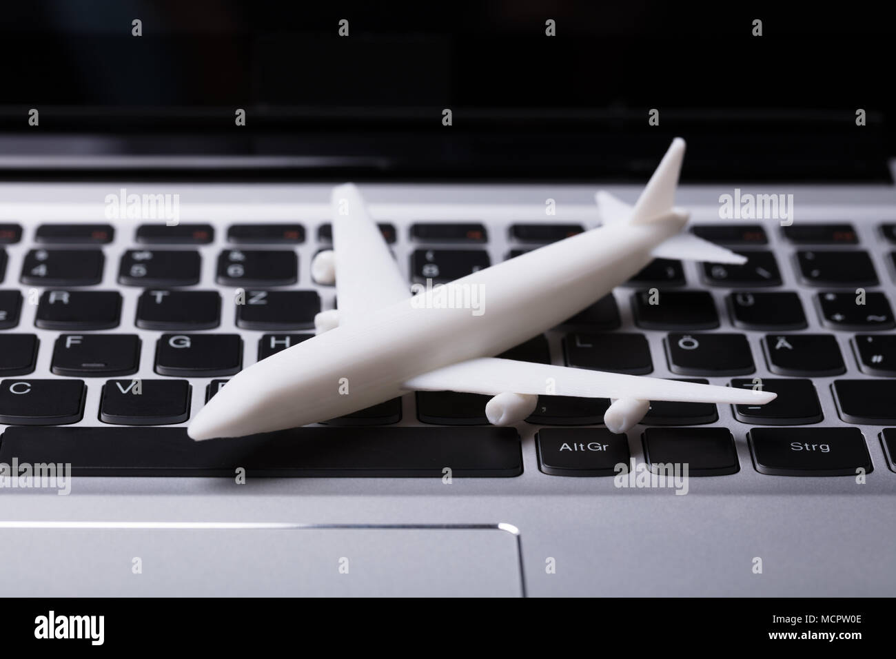 Elevated View Of White Airplane Miniature On Laptop Keypad Stock Photo ...