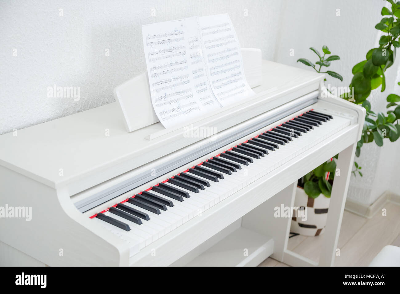 White piano in classroom Stock Photo - Alamy
