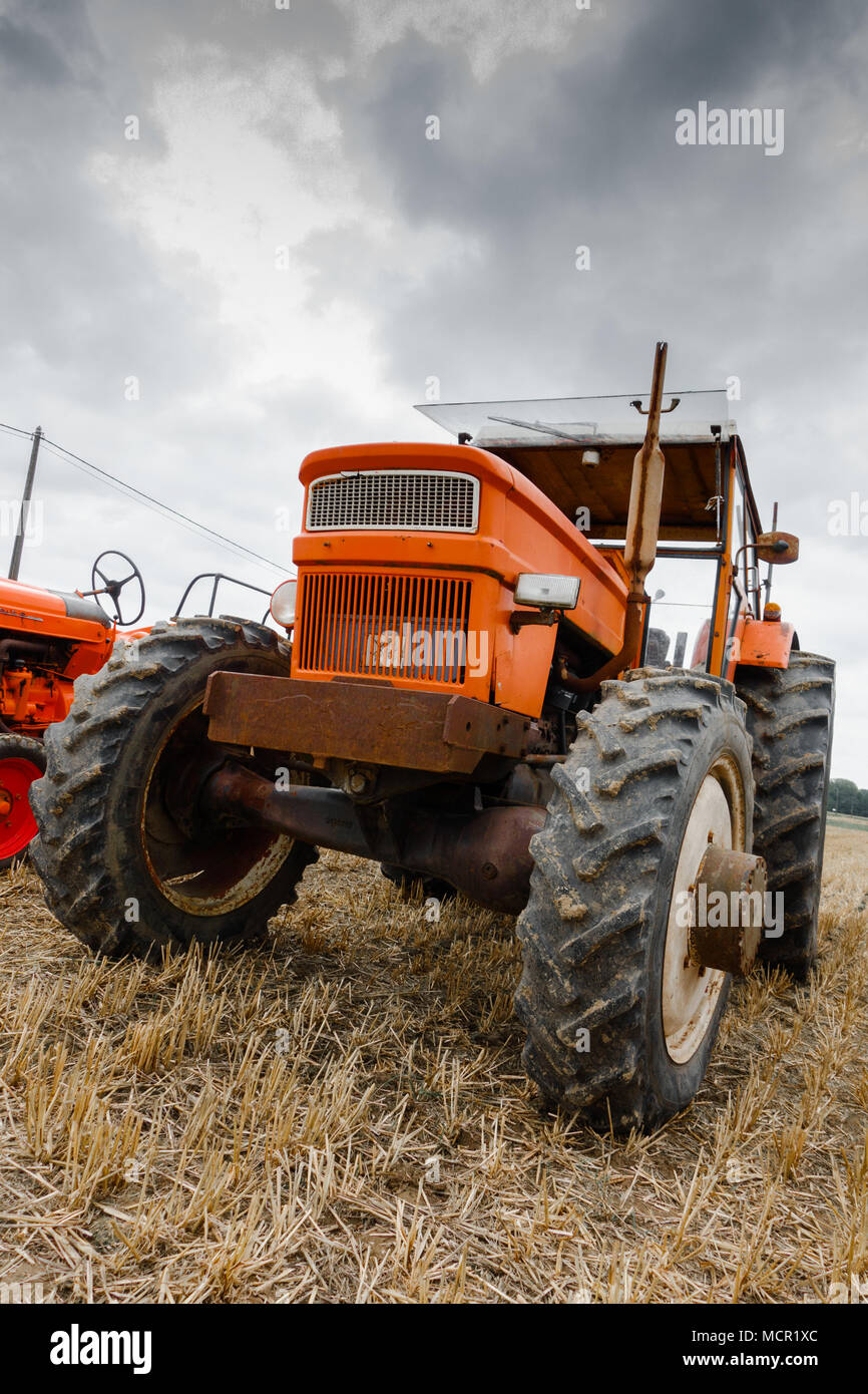 Front view of tractor on grass field Stock Photo - Alamy