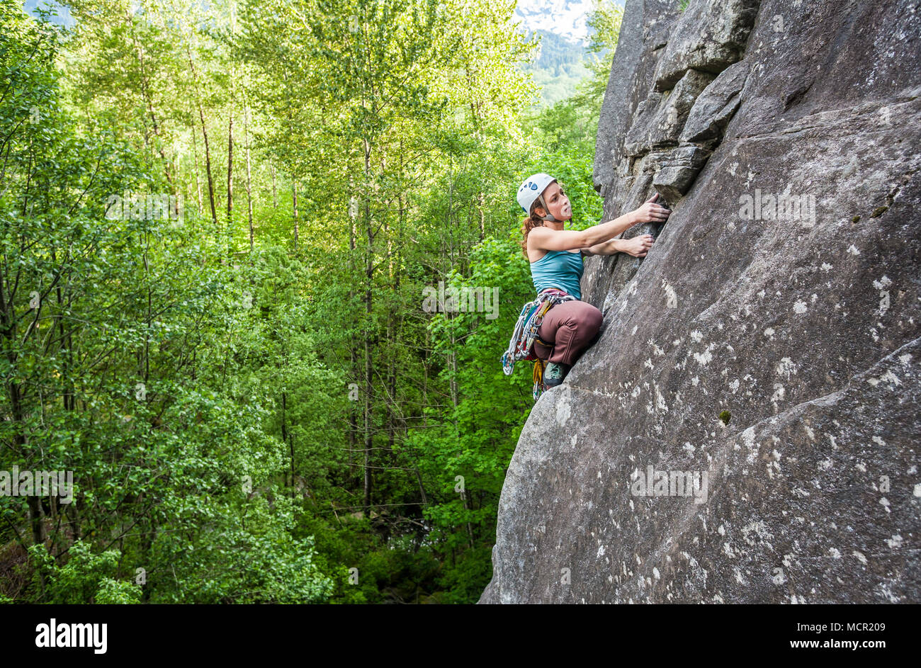 A young woman lead climbing at the lower town wall, Index, Washington ...