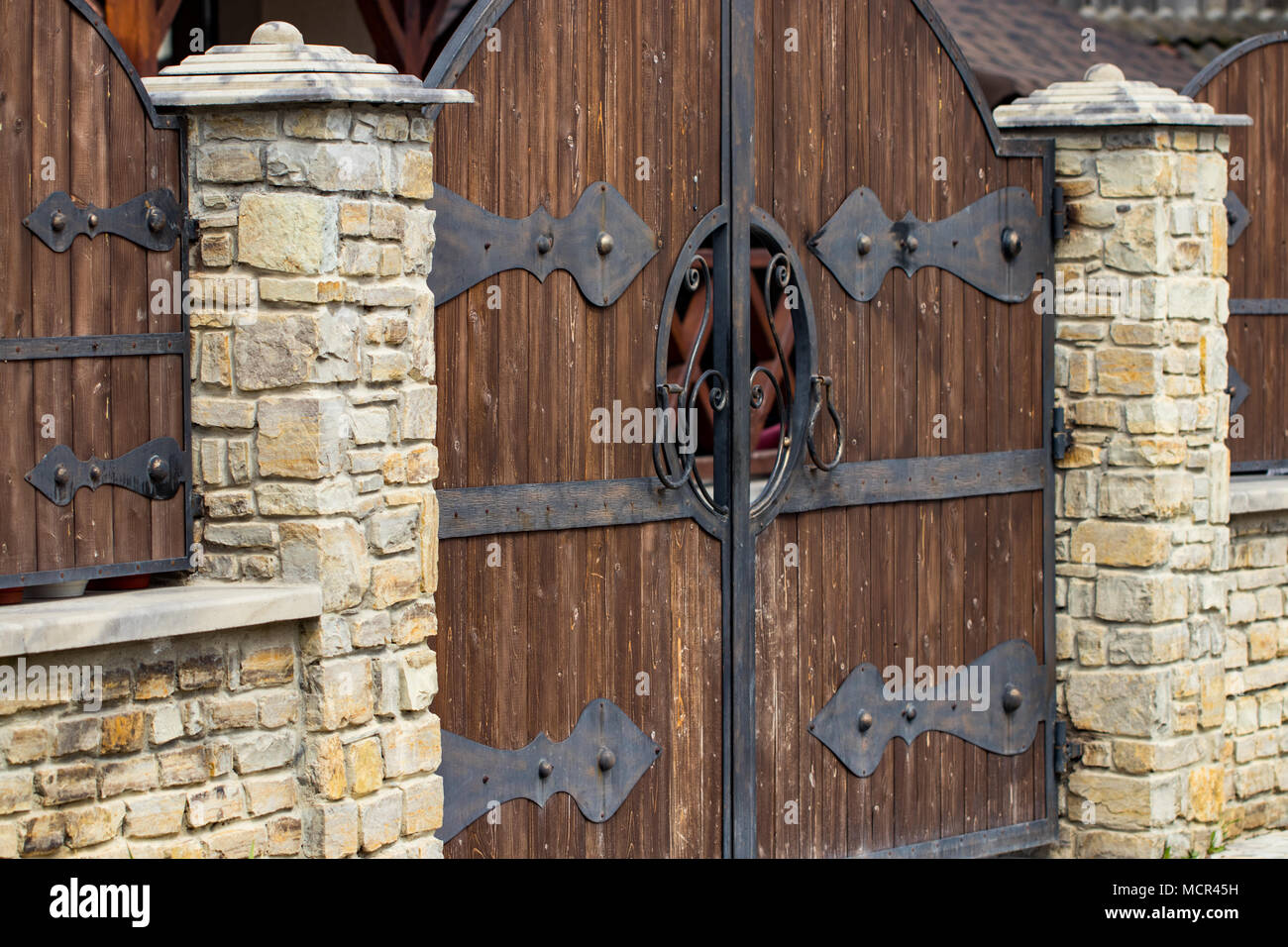 wooden gate with wrought iron elements close up Stock Photo - Alamy