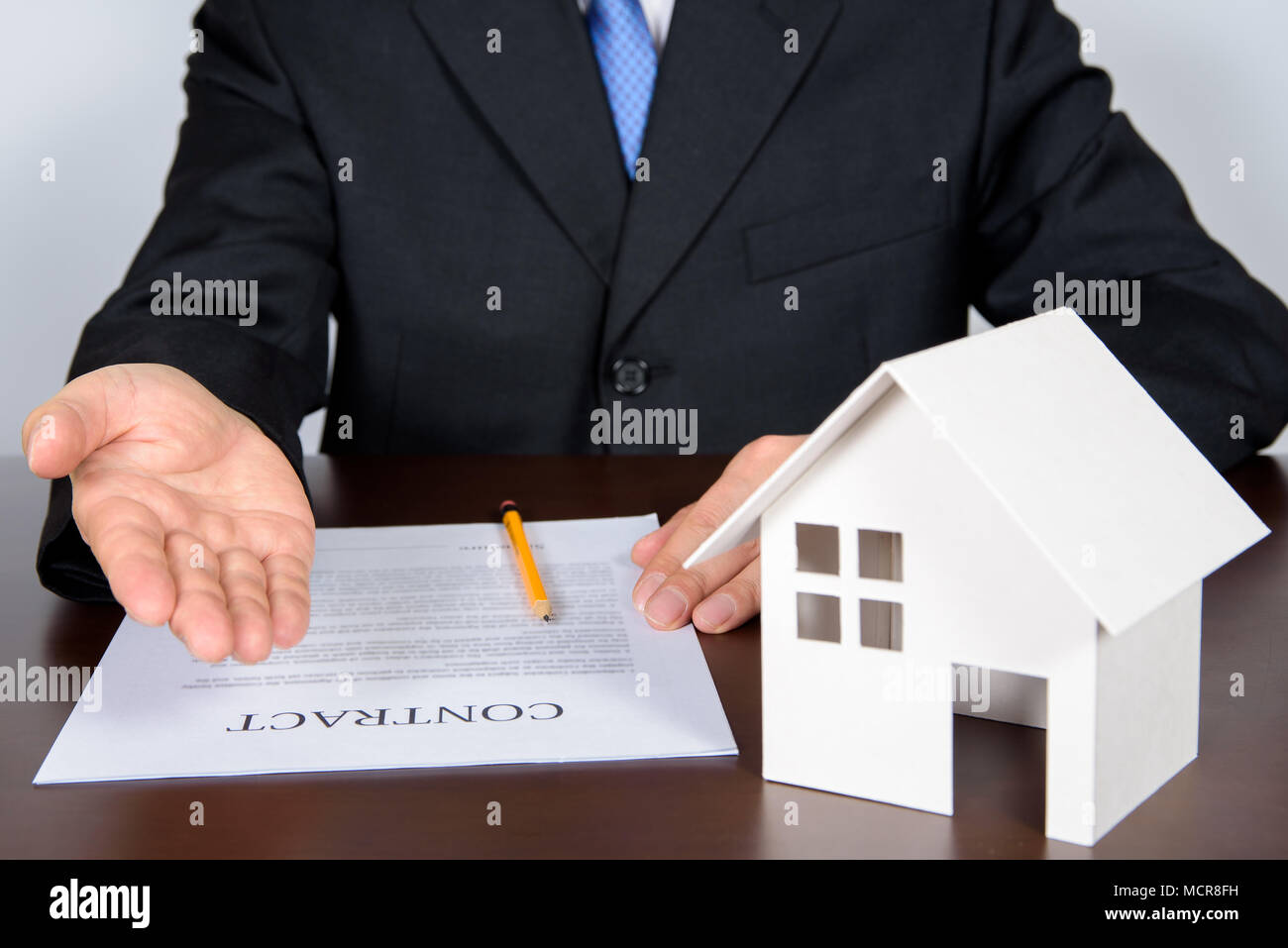 A businessman who invites real estate to consumers Stock Photo - Alamy