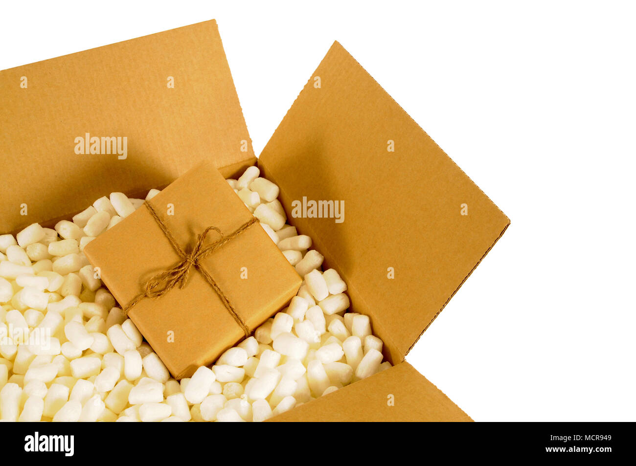Cardboard shipping box with small wrapped package inside Stock Photo ...