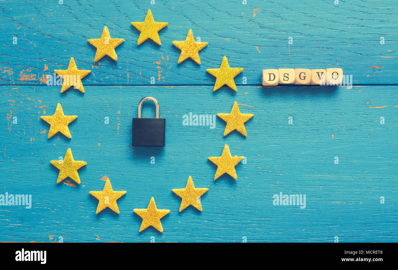 European Union sign with a padlock on a blue rustic wooden background ...