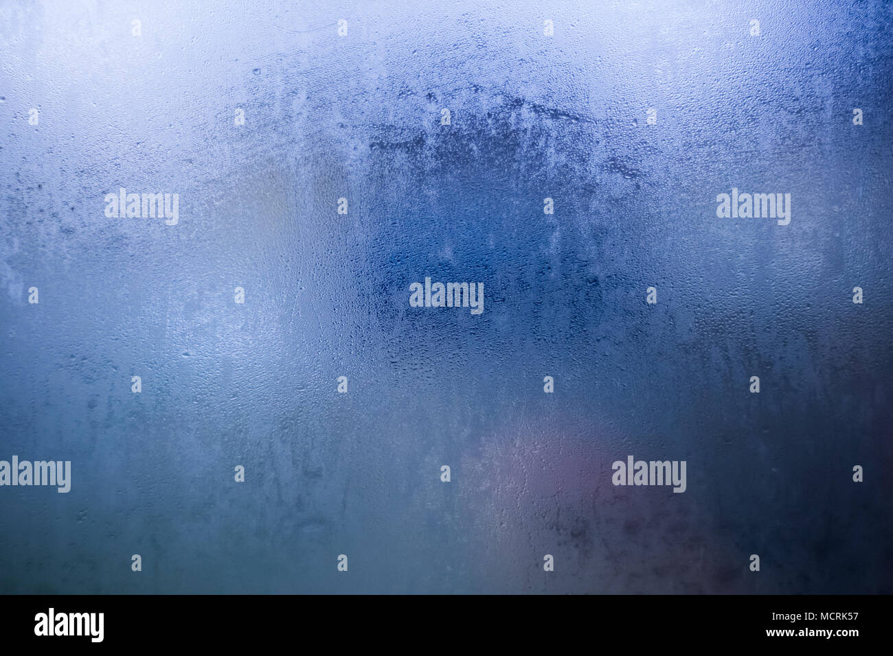 Condensed water on the window glass. Blue texture background of water ...
