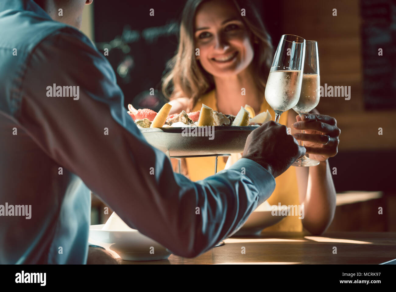 Happy couple in love toasting with champagne during romantic dinner ...