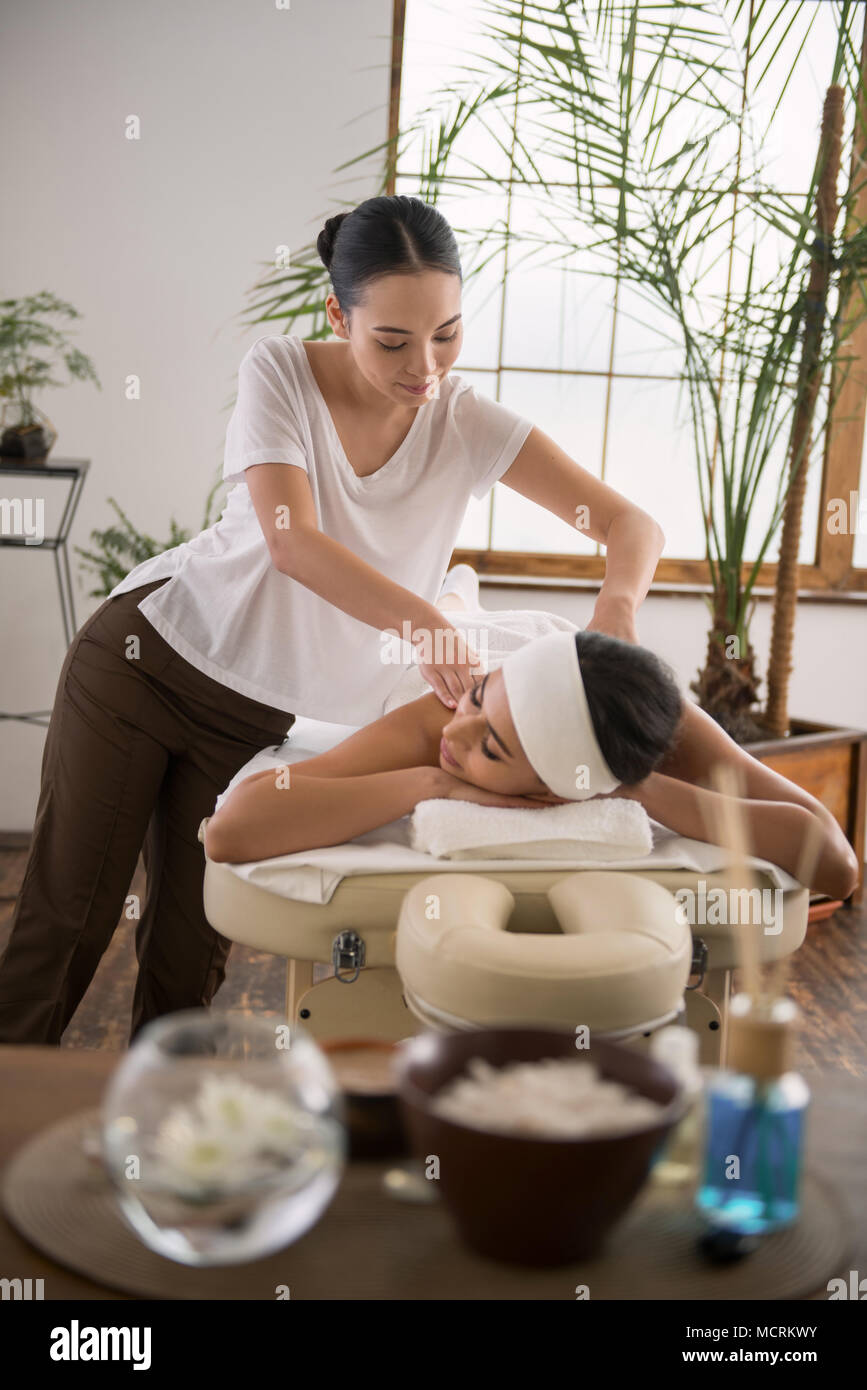 Joyful young masseuse doing her work Stock Photo - Alamy