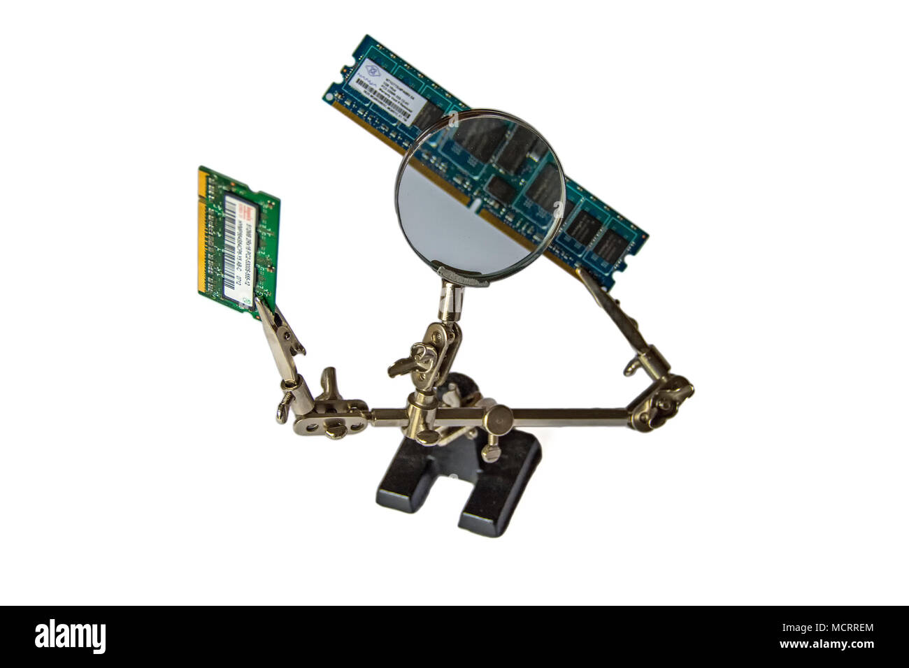 solder helping hands holding DDR memory. looks like a robot or as if it ...