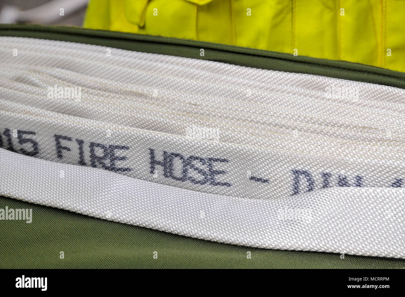 folded Fire hoses as Fire fighters equipment Stock Photo - Alamy