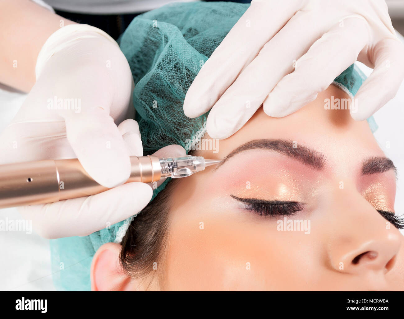 Applying permanent Makeup for Eyebrows. Beautician Doing Eyebrow ...