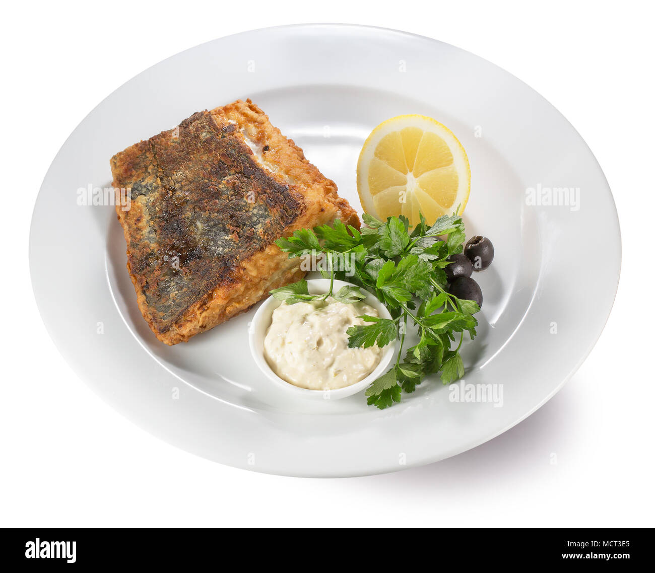 piece of fried fish with garnish Stock Photo - Alamy