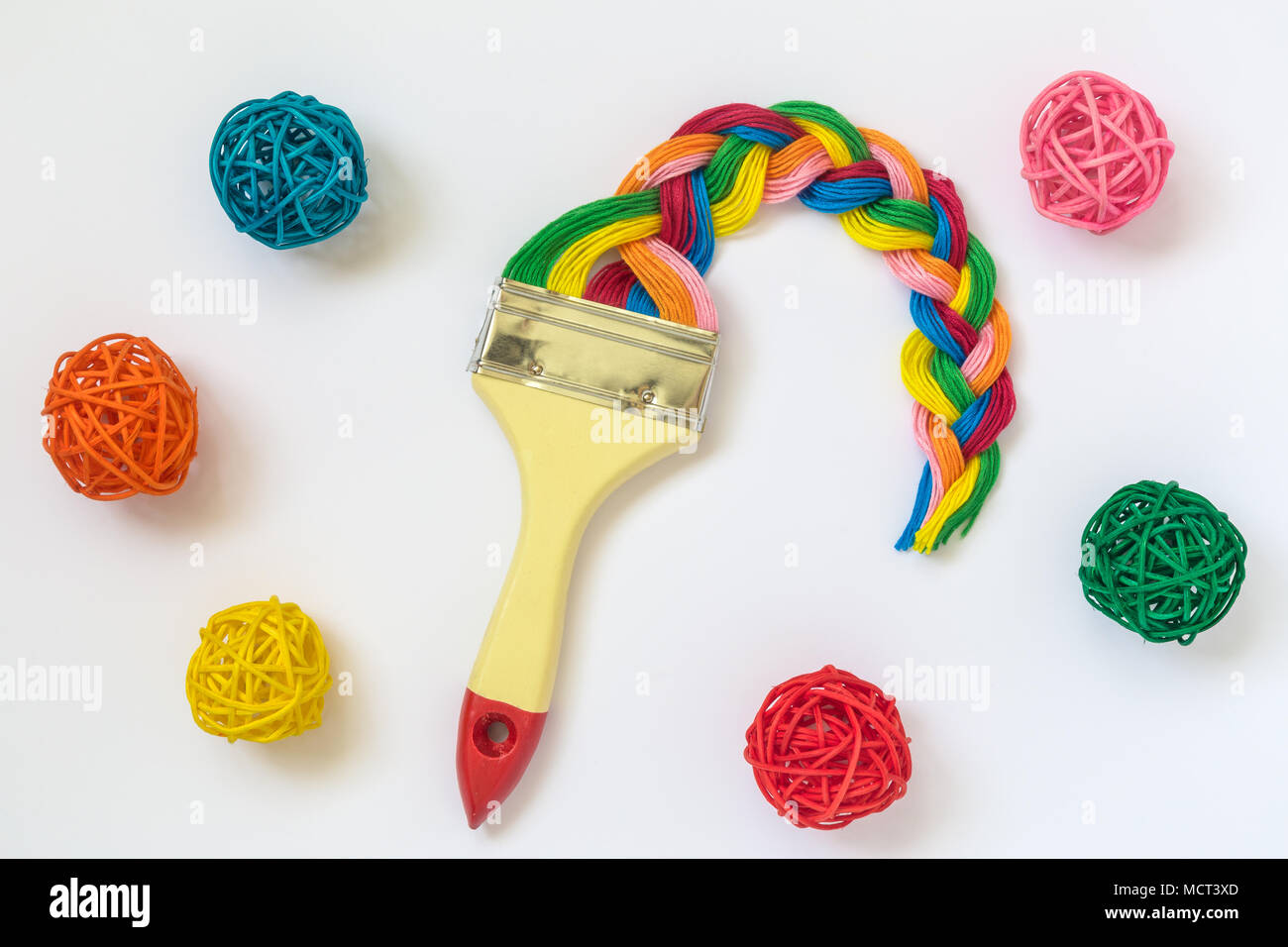 Paintbrush with long colorful strings braid and rattan balls isolated ...