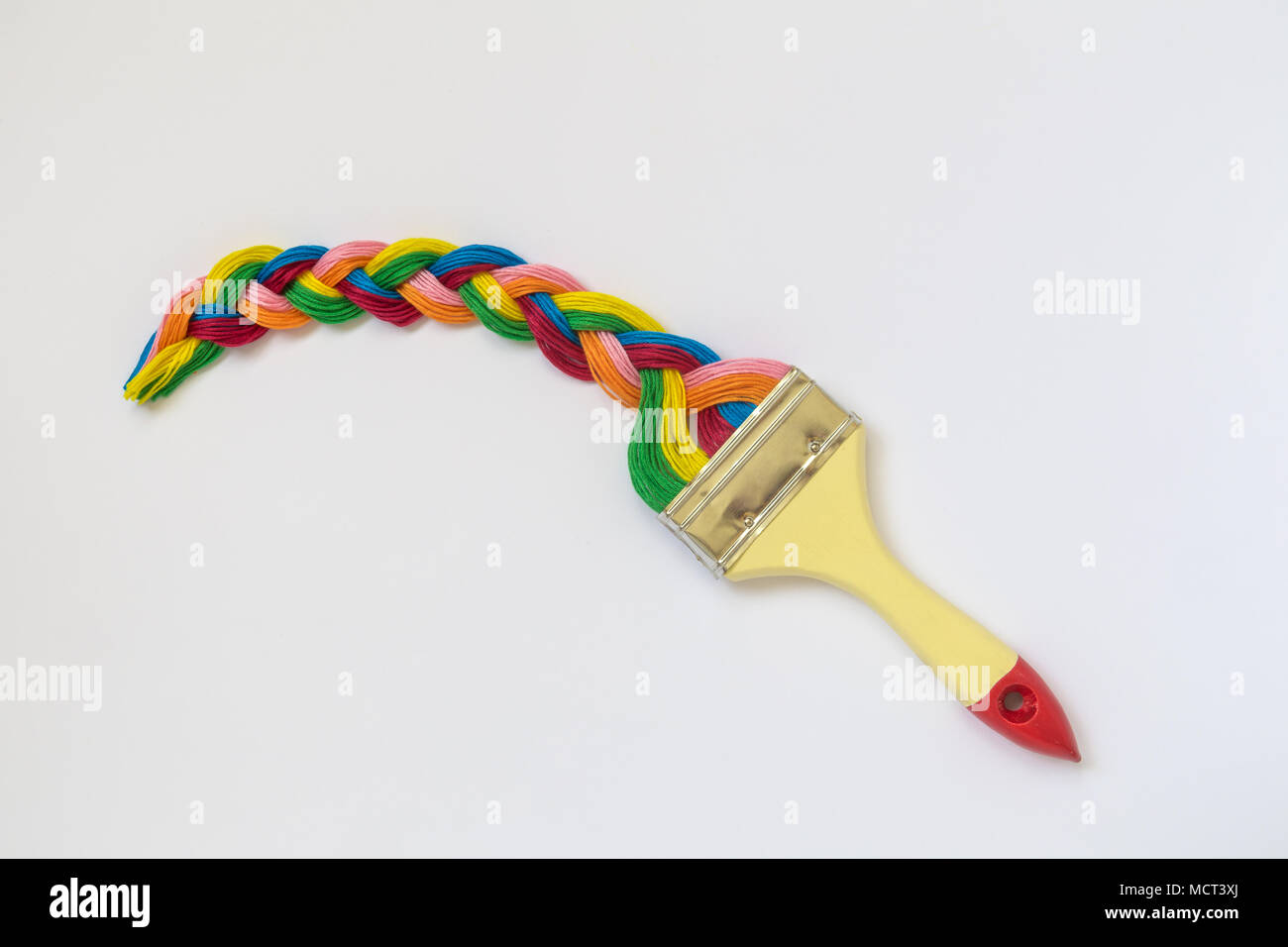 Paintbrush with long colorful strings braid isolated on white ...