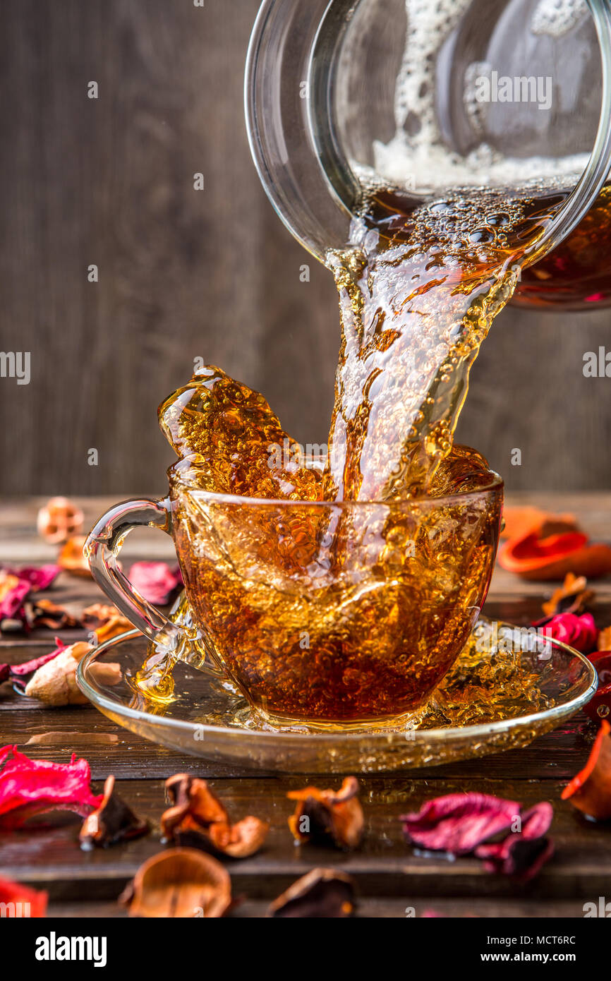 Black tea from pours teapot Stock Photo - Alamy