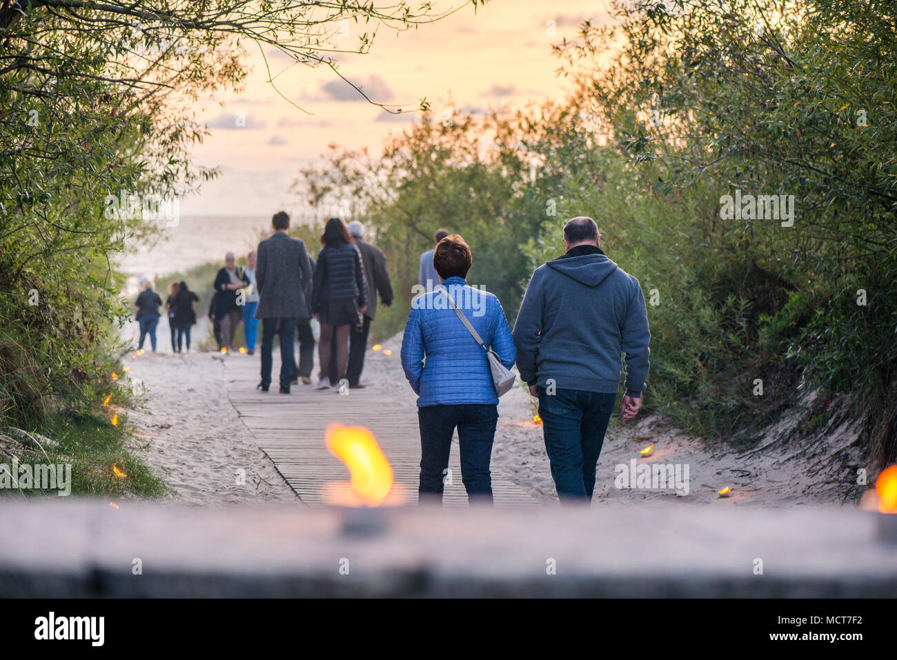 Romantic bonfire night at seaside during sunset. People gathering ...