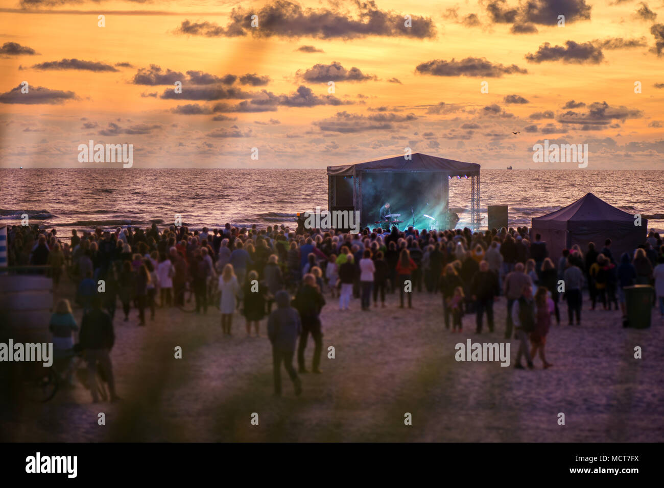 Crowd of unrecognizable people. Romantic concert at seaside during ...
