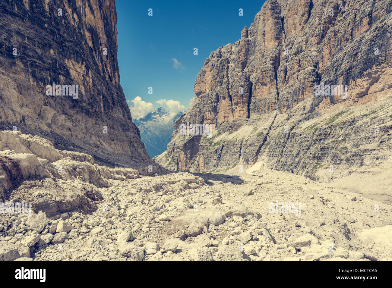Female trekker walking along mountain valley Stock Photo - Alamy
