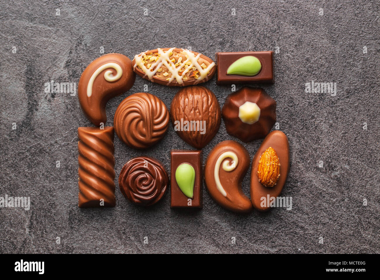 Mixed belgian pralines. Chocolate truffles on old kitchen table Stock ...