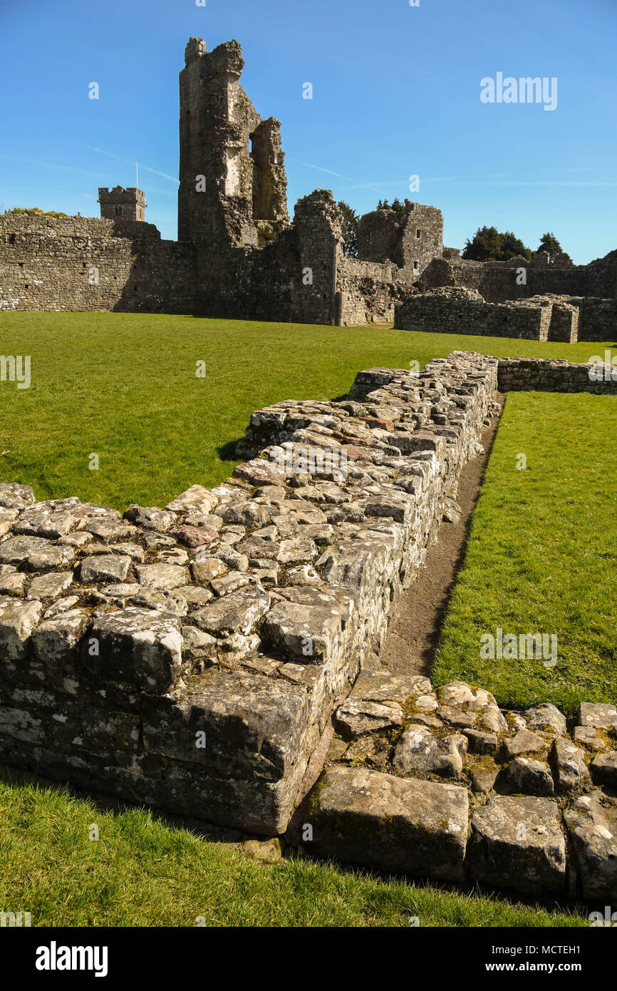 Remains of a wall in the grounds of Coity Castle with the inner bailey ...