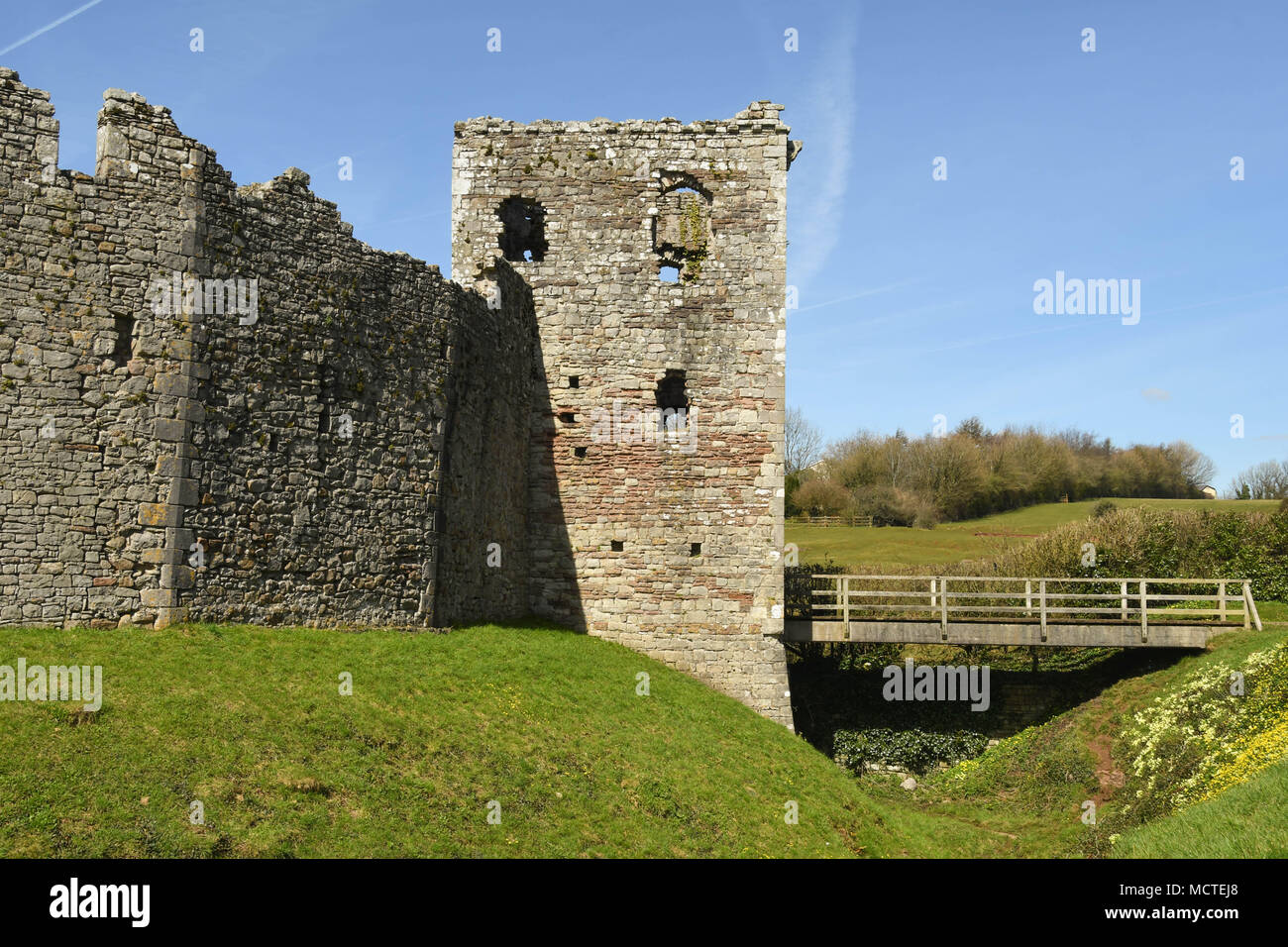 The gatehouse and curtain wall of Coity Castle and the wooden bridge ...