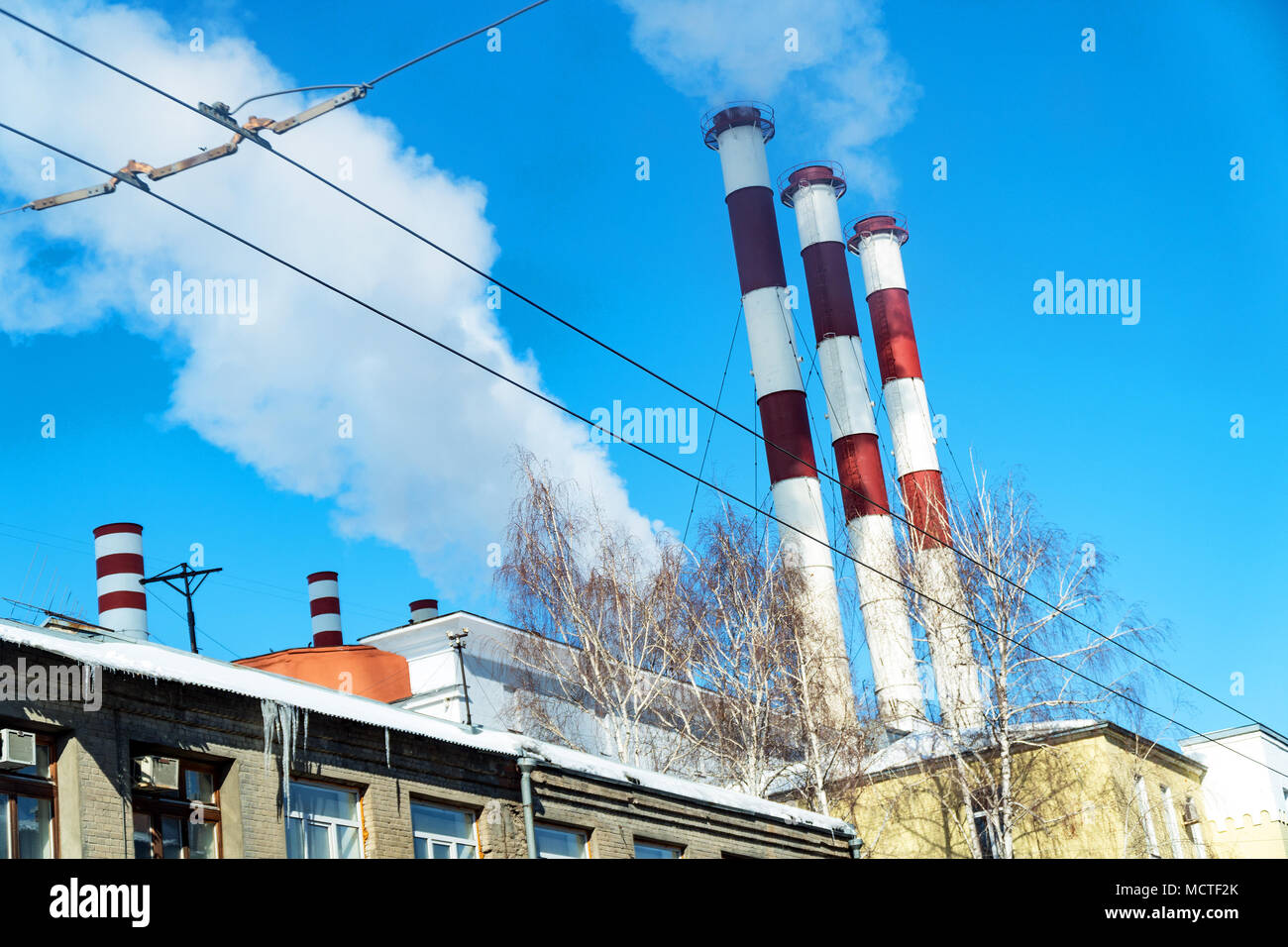 Three factory pipes smoke Stock Photo - Alamy