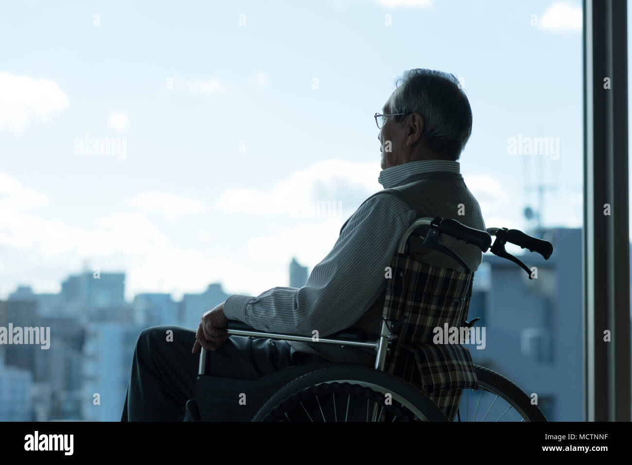 Senior man sitting in wheelchair Stock Photo - Alamy