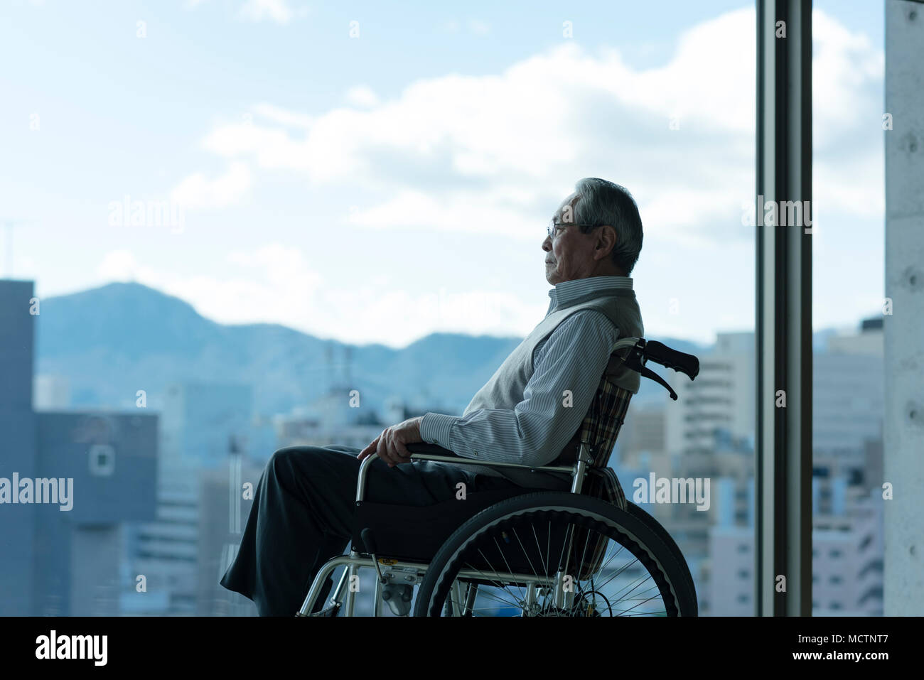 Senior man sitting in wheelchair Stock Photo - Alamy