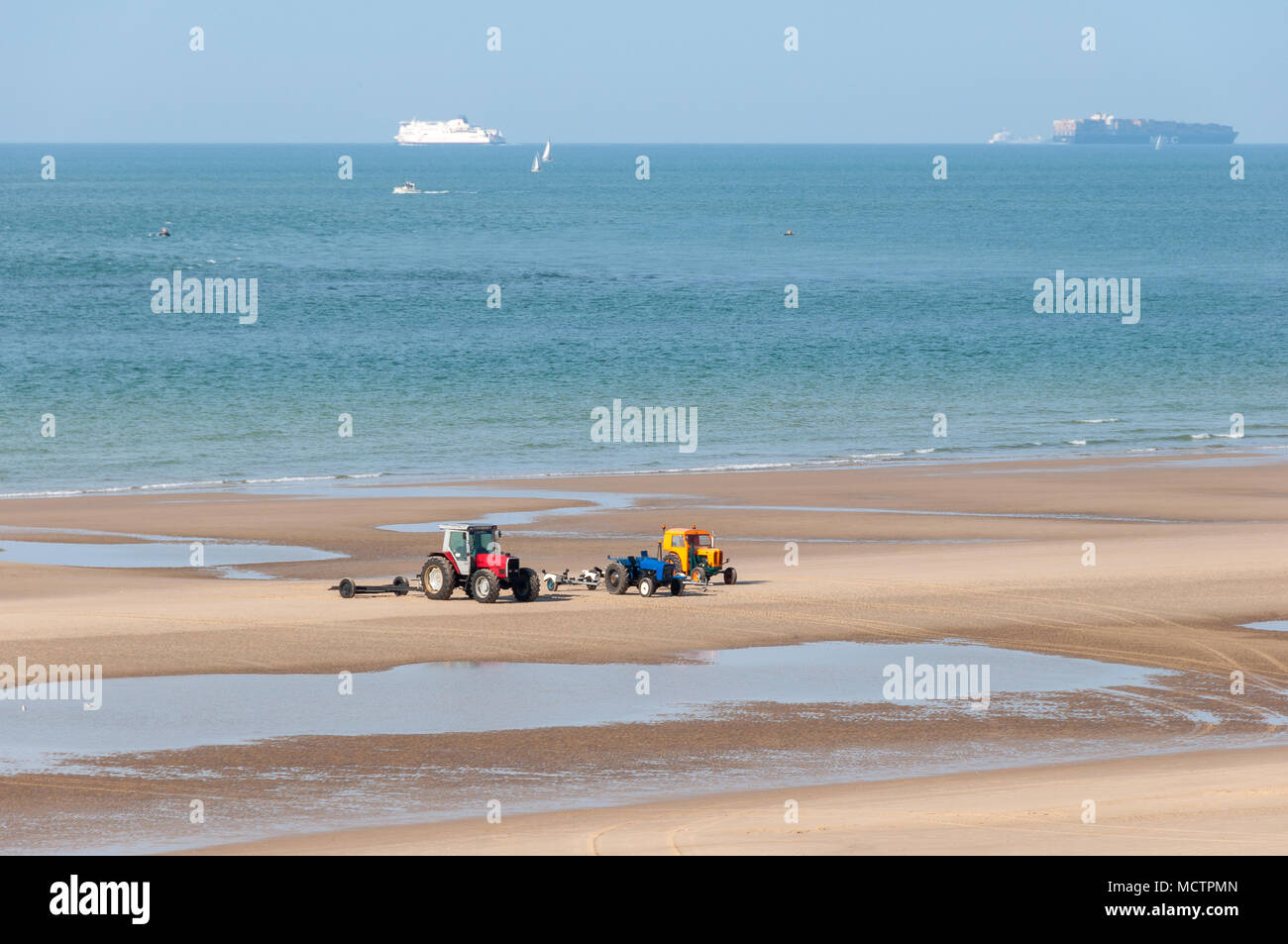 Tractor and trailers for fishing boats on the beach Stock Photo - Alamy