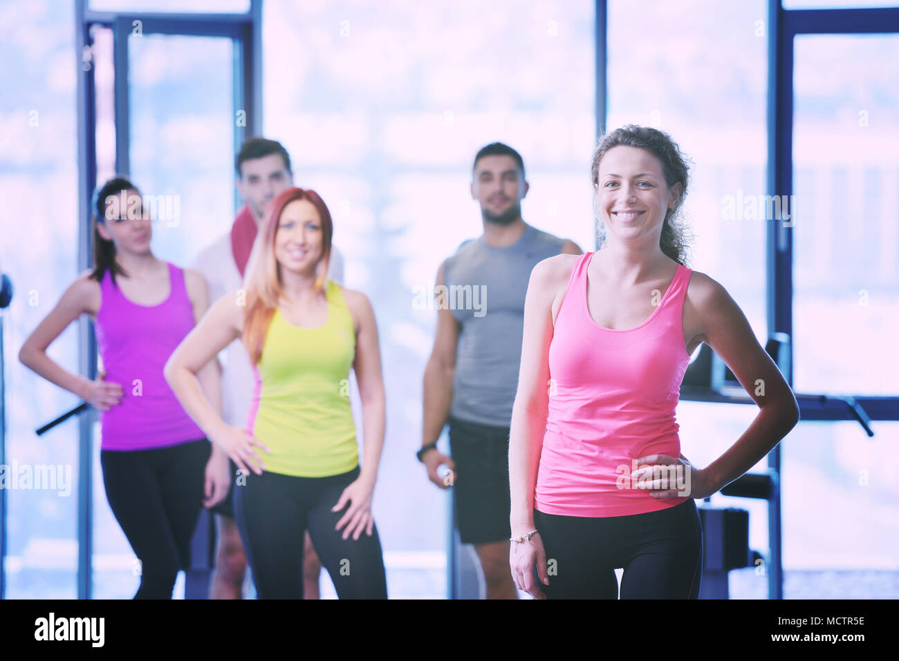 Group of people exercising at the gym and stretching Stock Photo - Alamy