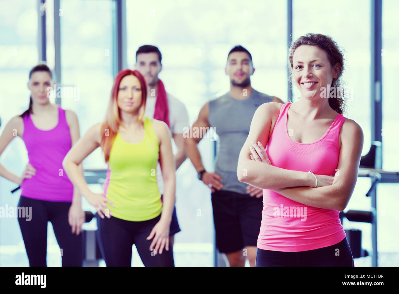 Group of people exercising at the gym and stretching Stock Photo - Alamy