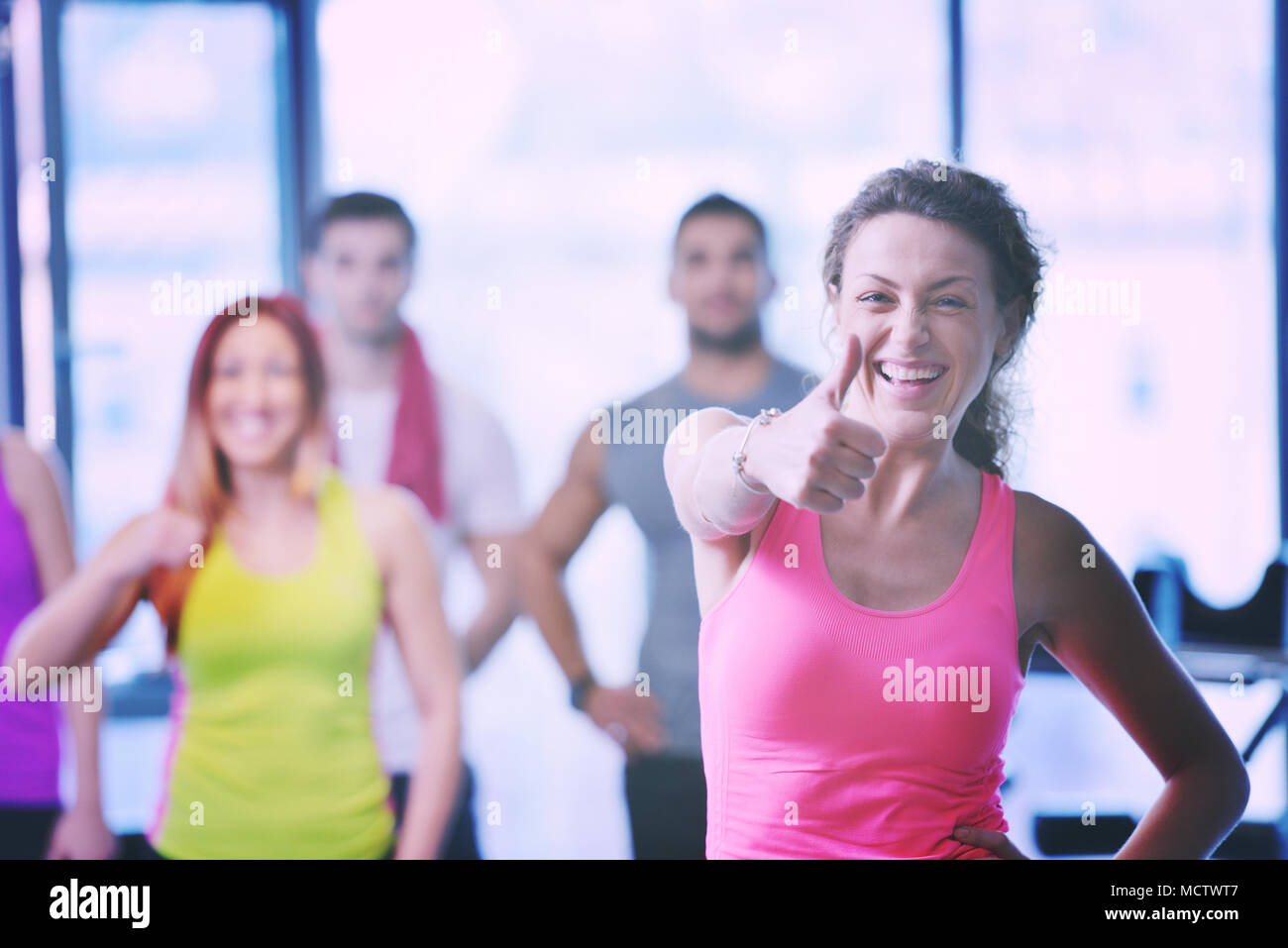 Group of people exercising at the gym and stretching Stock Photo - Alamy