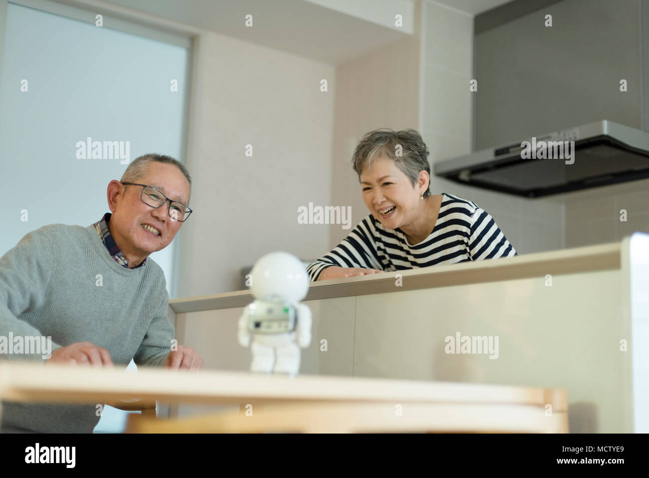 Senior couple talking to robot Stock Photo - Alamy