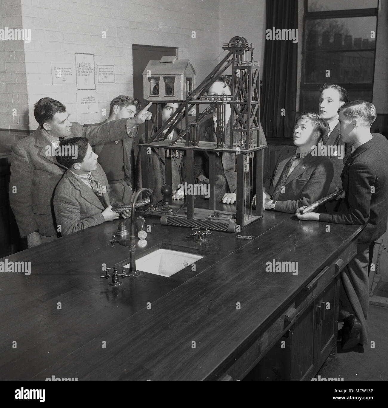 1950s, historical, Mining students in a college classroom being shown a ...