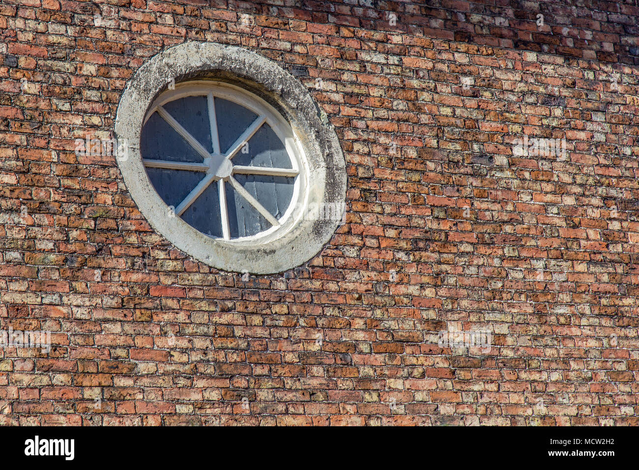 Round window in brick wall hi-res stock photography and images - Alamy
