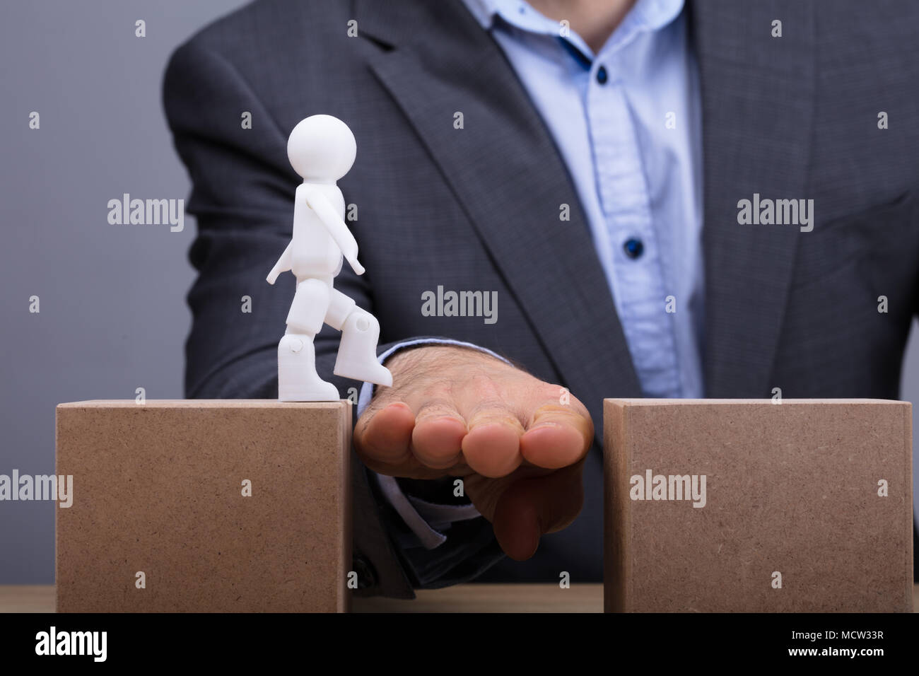 Close-up Of A Person's Hand Helping Human Figure While Walking Between ...