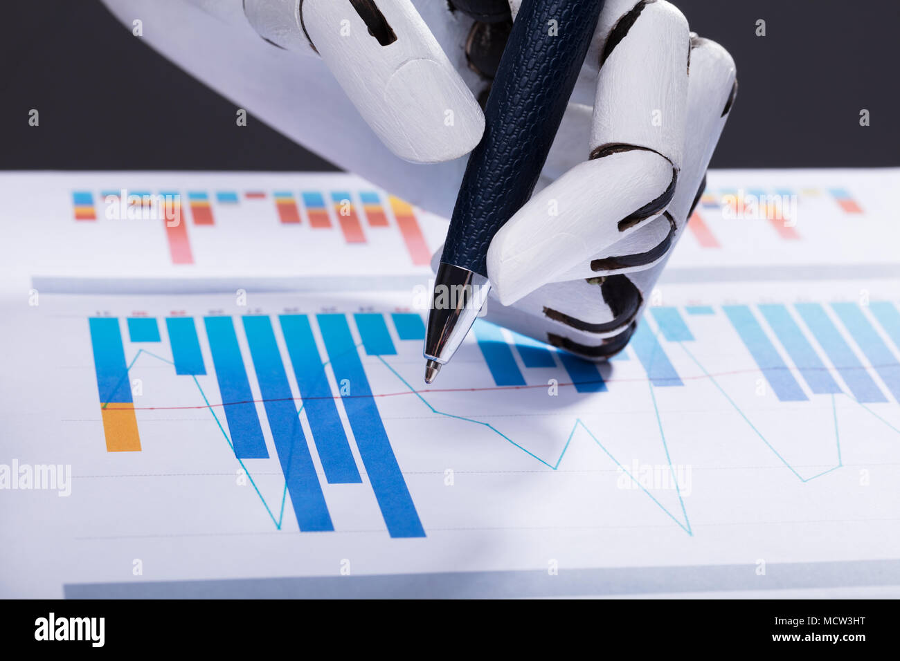 Close-up Of A Robotic Hand Using Pen While Working On Graph Stock Photo ...