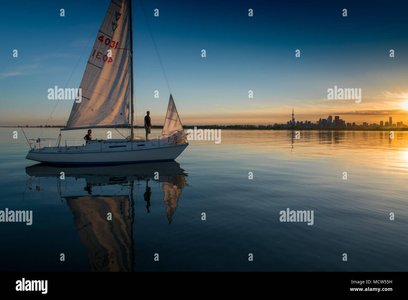 Sailboat and seascape with city skyline in distant, Toronto, Canada ...