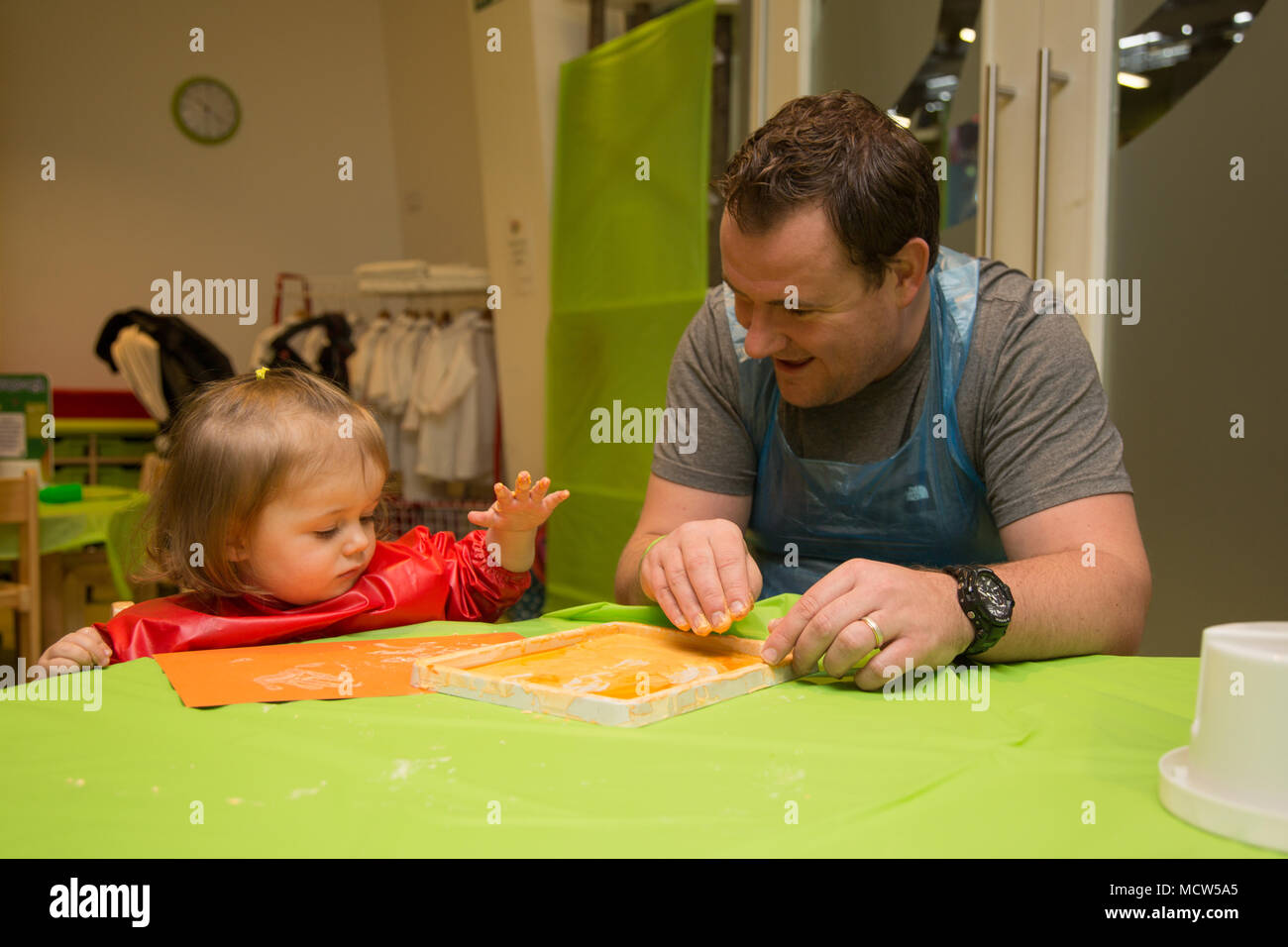Father and daughter at messy play Stock Photo - Alamy