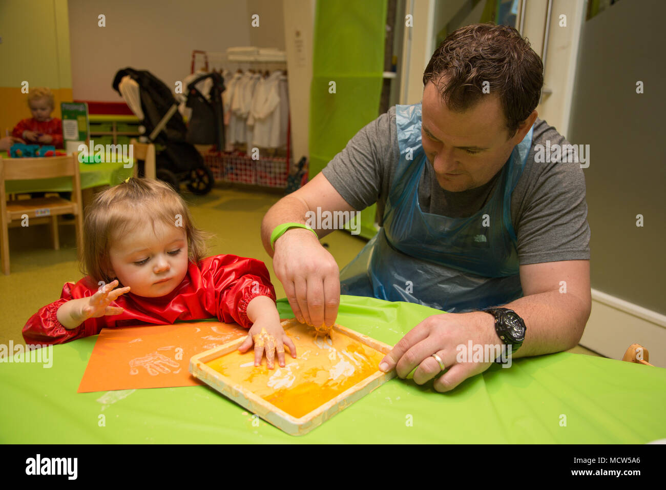 Father and daughter at messy play Stock Photo - Alamy