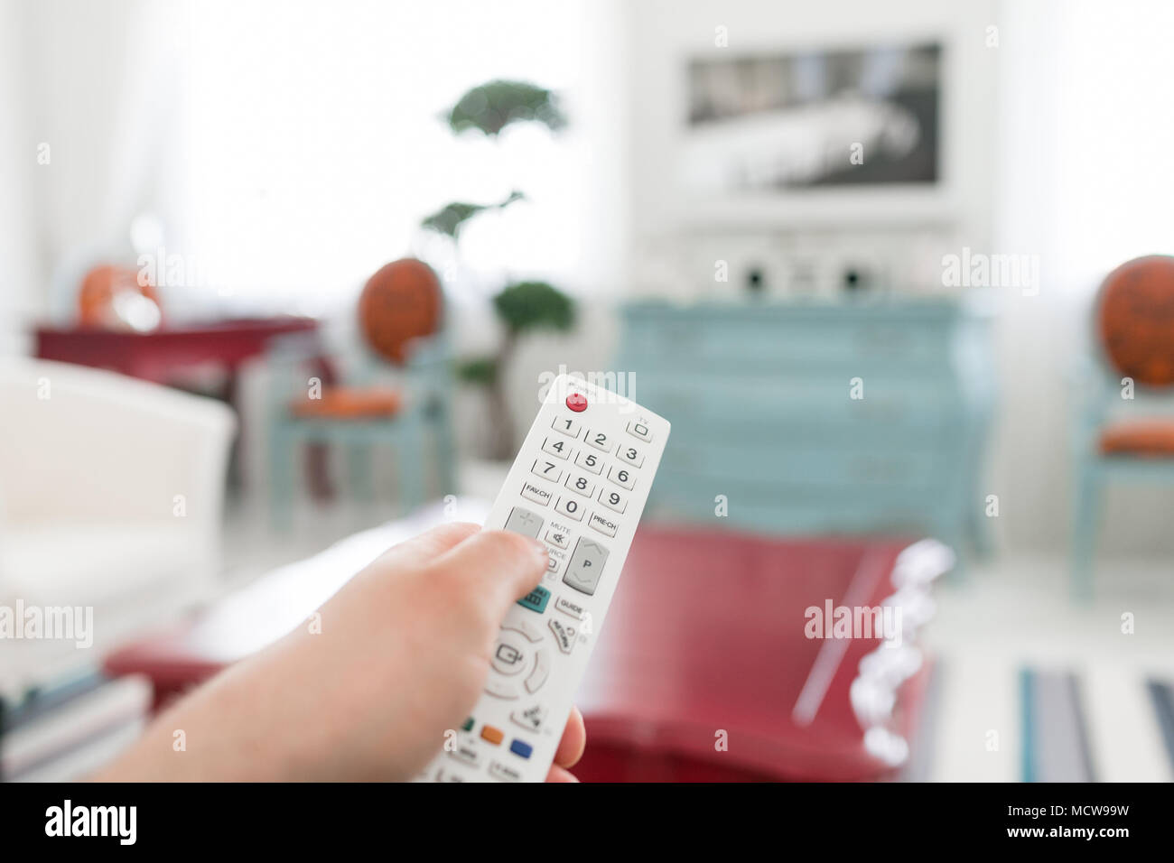 Using white remote control. Program switching or button pressing on TV ...