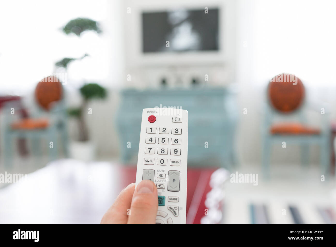 Using white remote control. Program switching or button pressing on TV ...