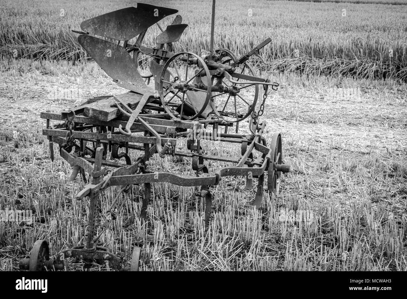Agricultural equipment on grass field Stock Photo - Alamy