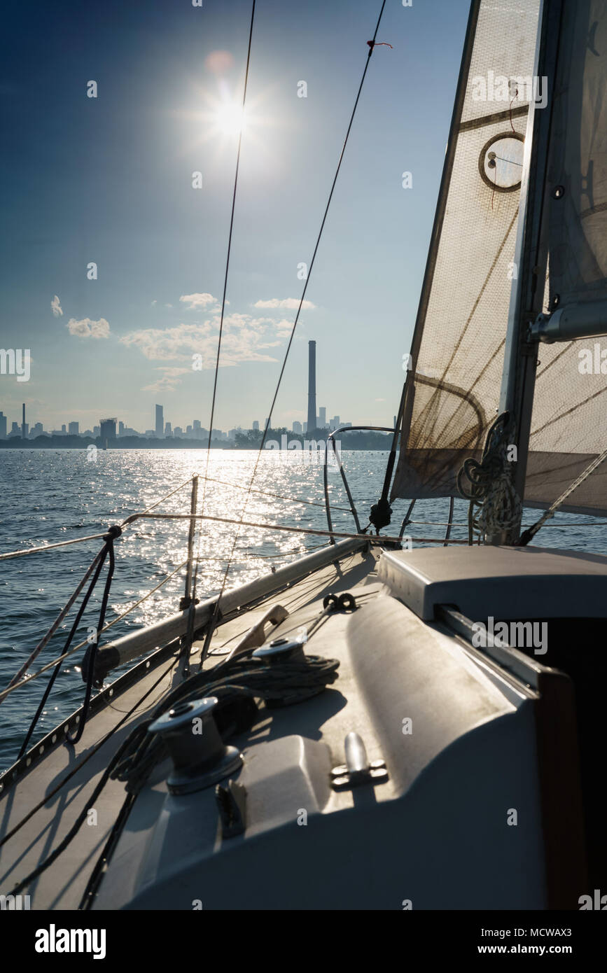 Sailboat and seascape with city skyline at distant, Toronto, Canada ...