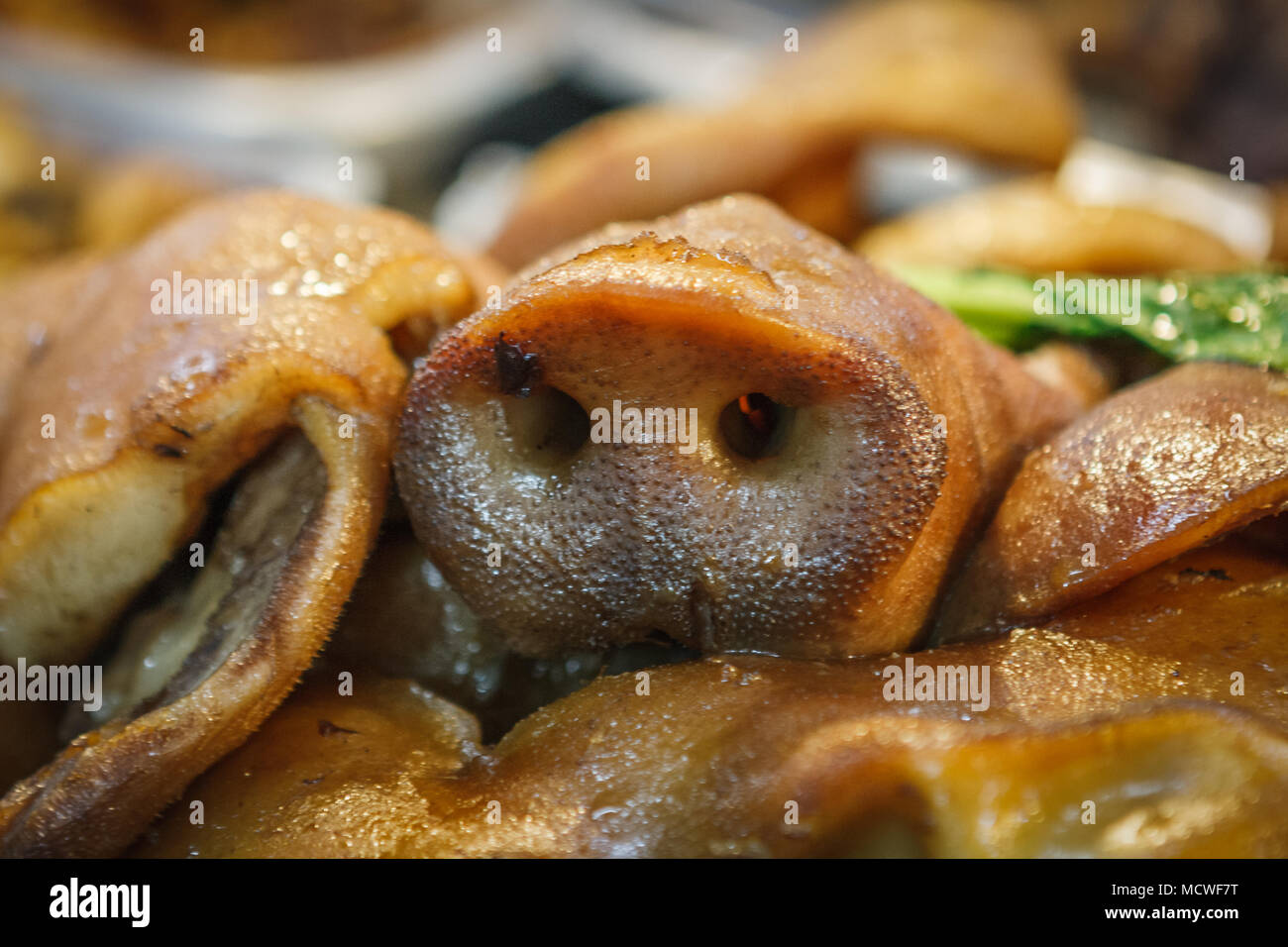 Detail of a pork nose at a street food stall at the weekend market ...