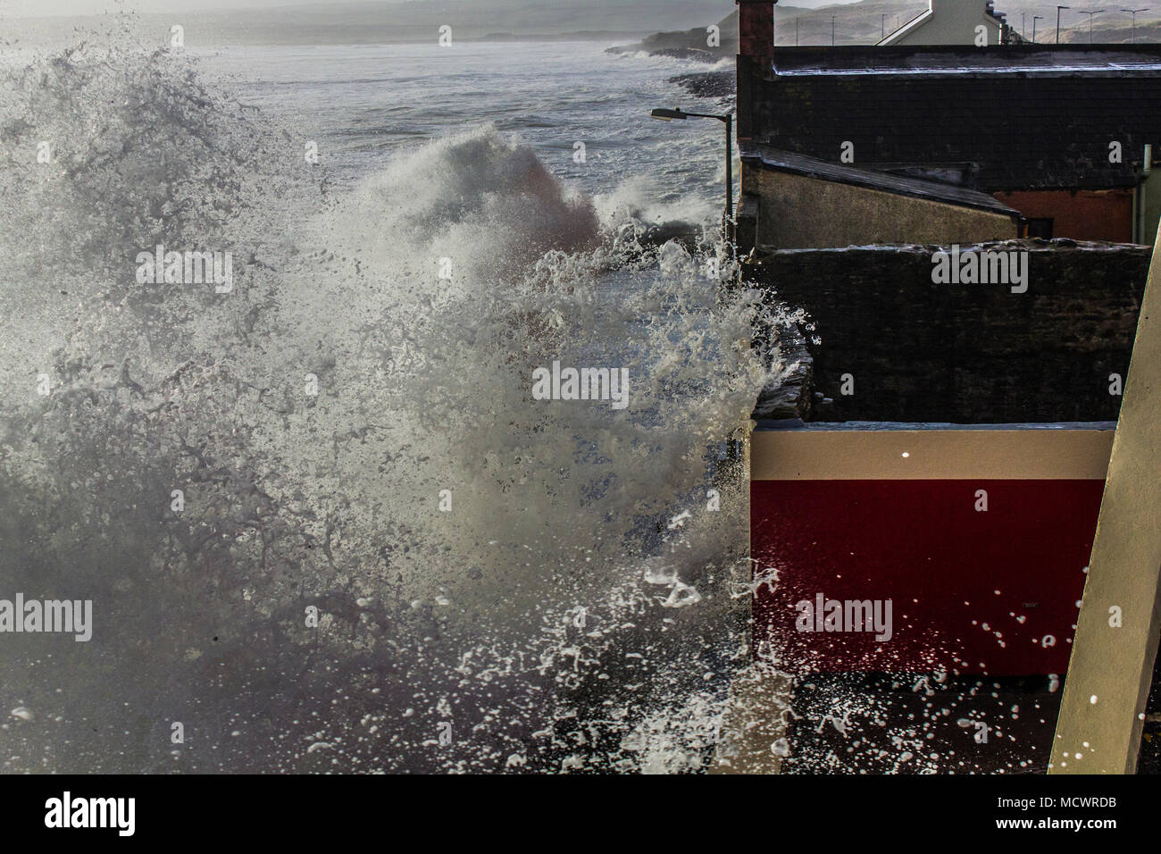 Wave coming over promenade and hitting buildings taken from above Stock ...