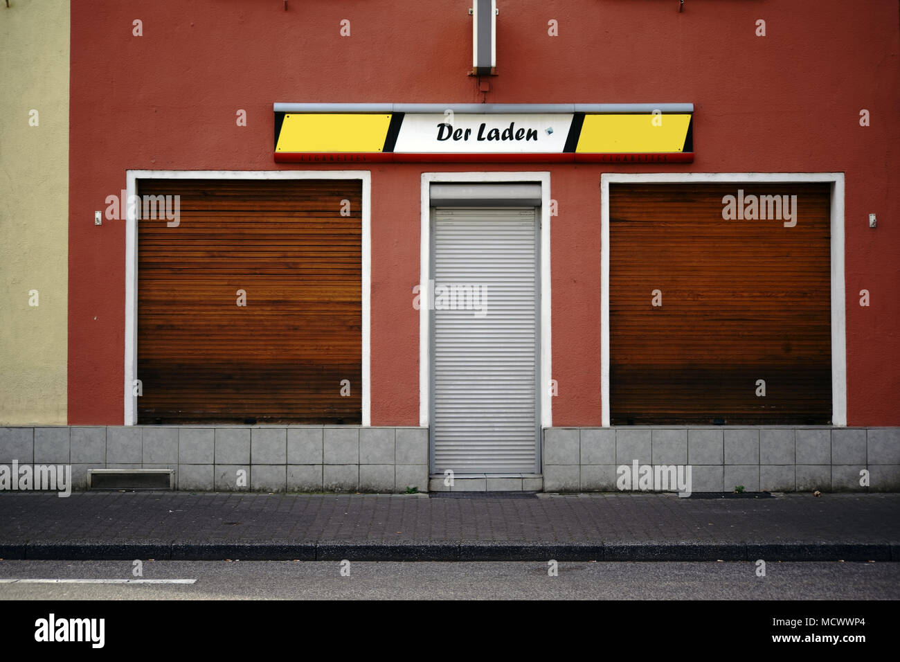 A closed shop and kiosk with lowered window shutters Stock Photo - Alamy
