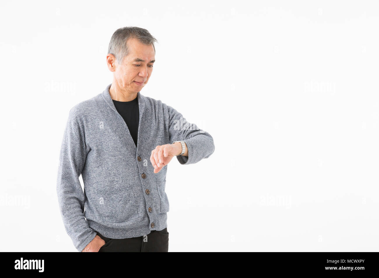 Senior man looking at her watch hi-res stock photography and images - Alamy