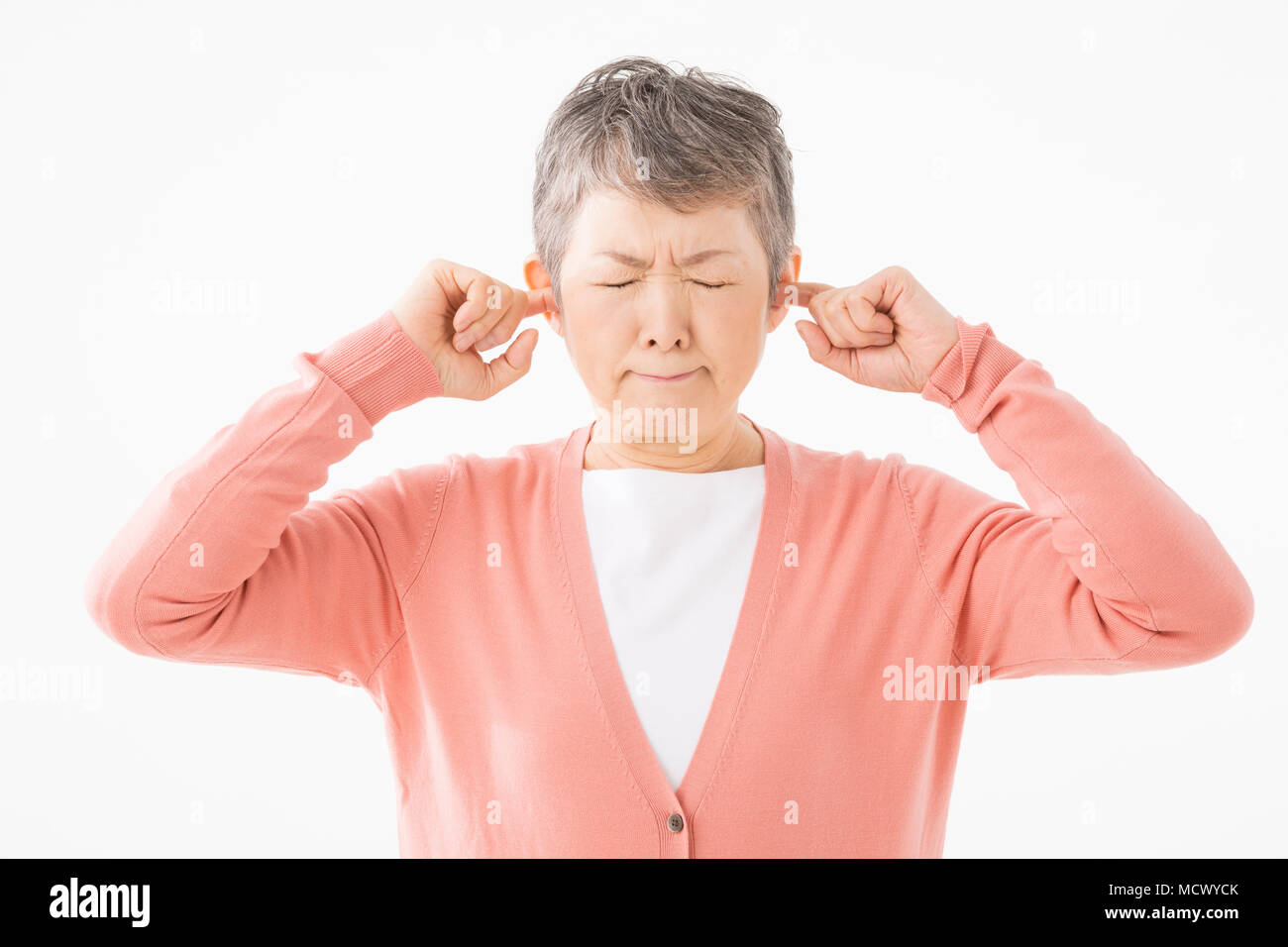 Elderly woman with hands on her ears hi-res stock photography and ...